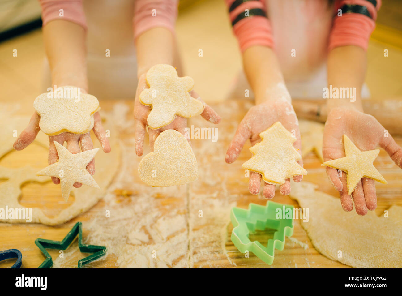 Little chefs show dough cut out by cookie cutters Stock Photo - Alamy