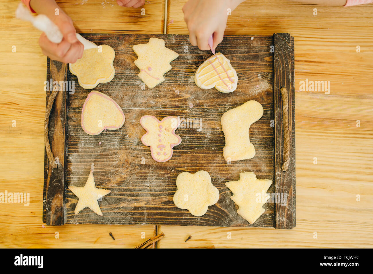 Little girls chefs spread out cookies on board Stock Photo - Alamy