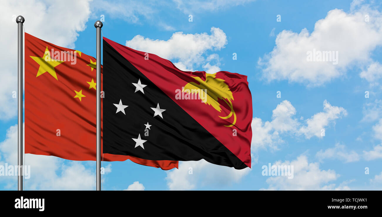 China and Papua New Guinea flag waving in the wind against white cloudy ...