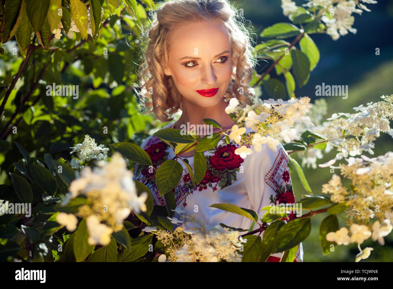 Closeup portrait of attractive blonde young woman with makeup and curly ...