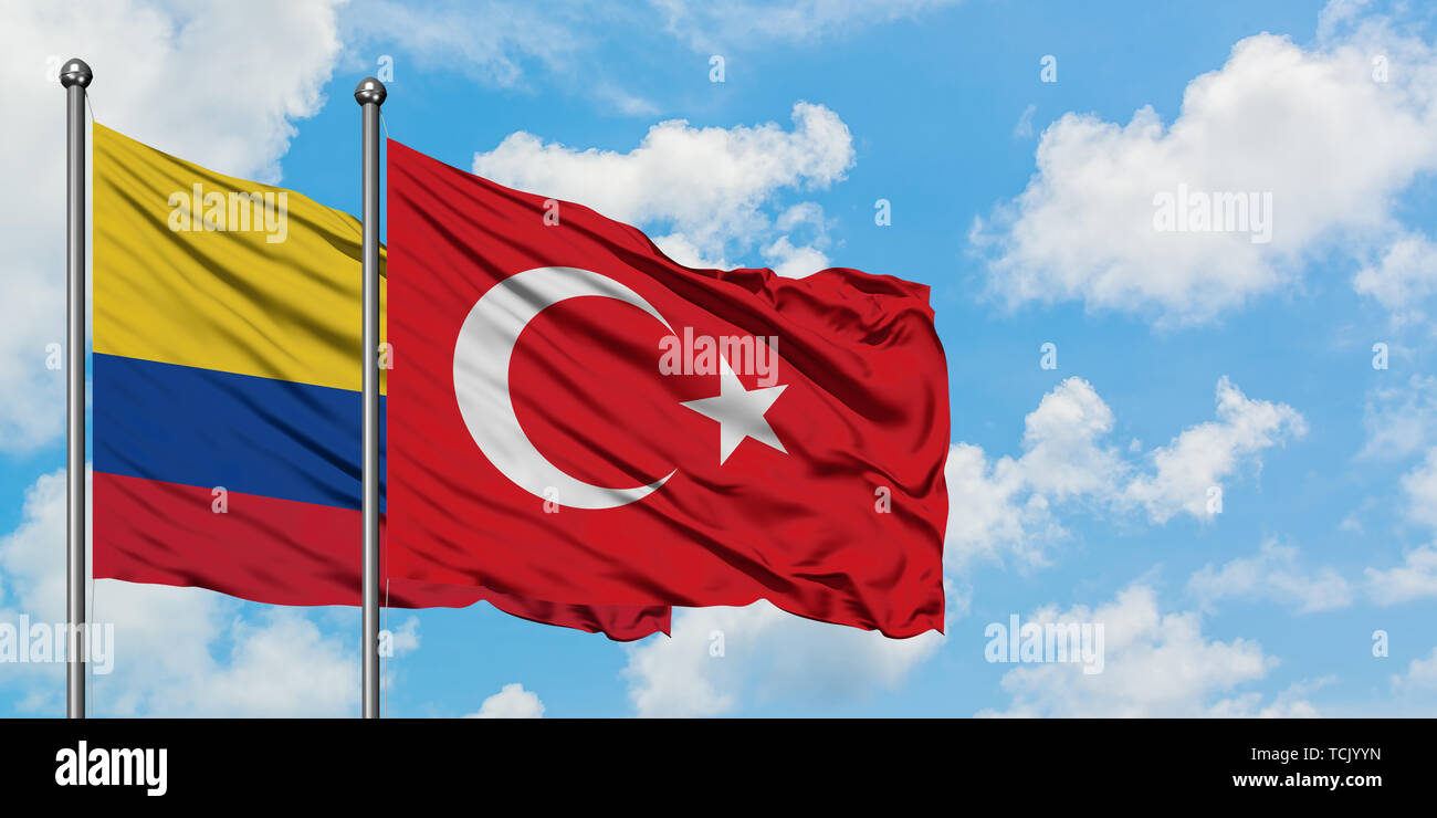 Colombia and Turkey flag waving in the wind against white cloudy blue ...