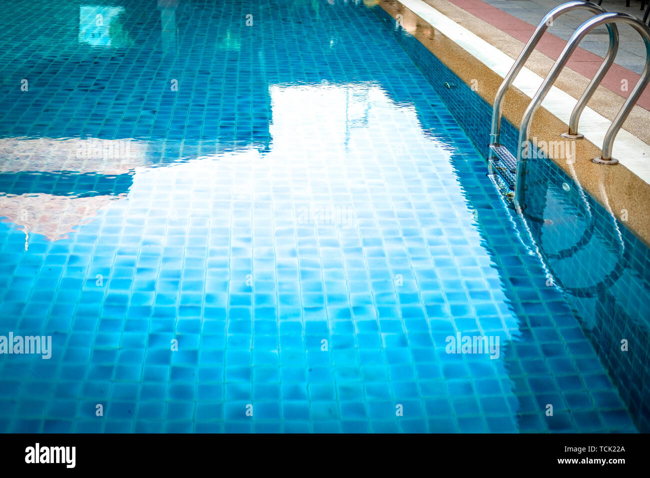 metal steel handle at edge poolside of swimming pool in hotel resort ...