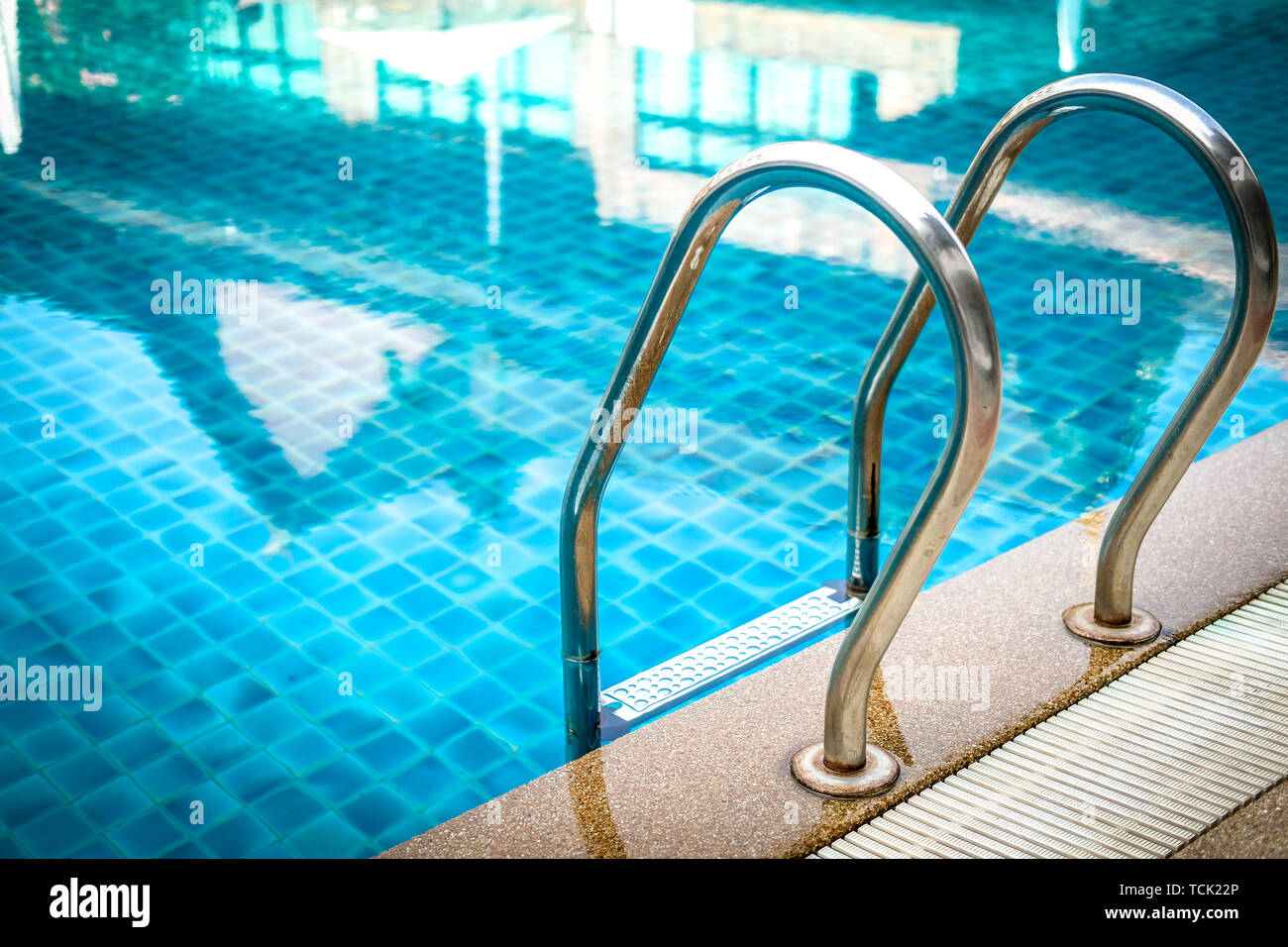 metal steel handle at edge poolside of swimming pool in hotel resort ...