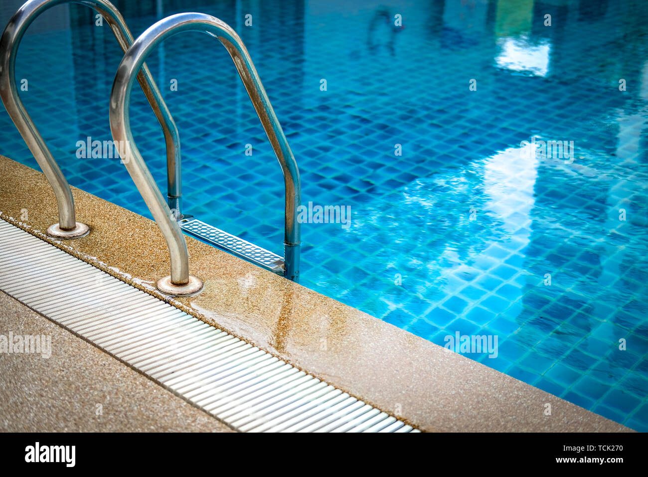 metal steel handle at edge poolside of swimming pool in hotel resort ...