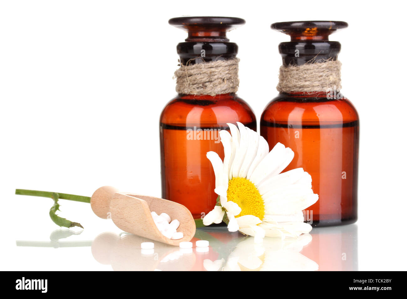 medicine bottles with tablets and flowers isolated on white Stock Photo ...