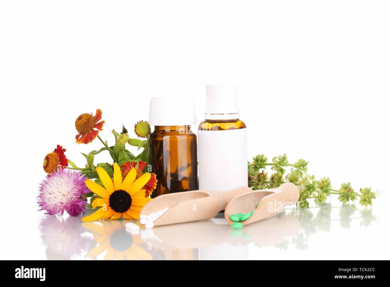 medicine bottles with tablets and flowers isolated on white Stock Photo ...