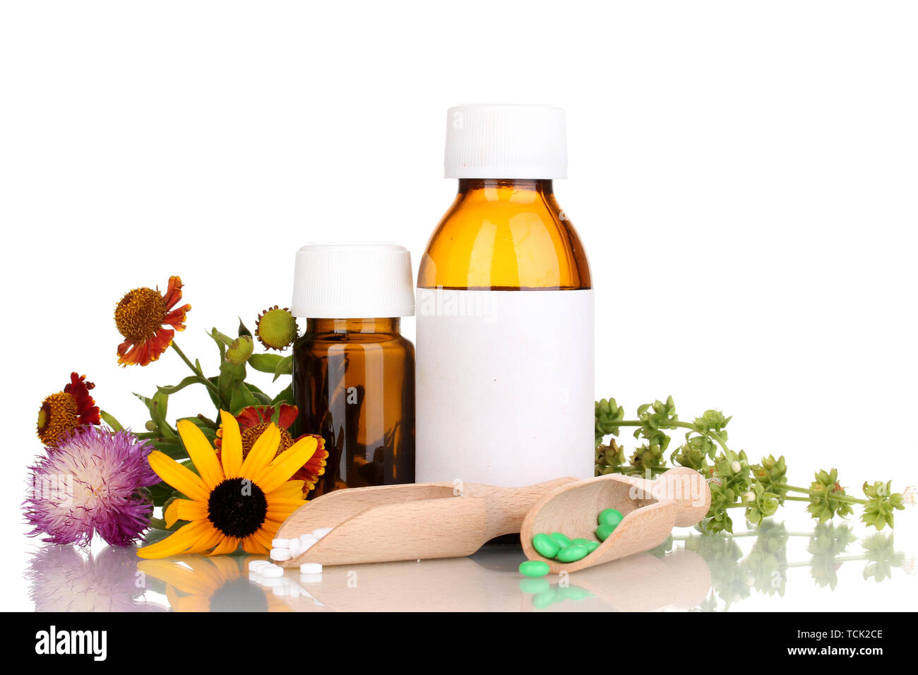 medicine bottles with tablets and flowers isolated on white Stock Photo ...