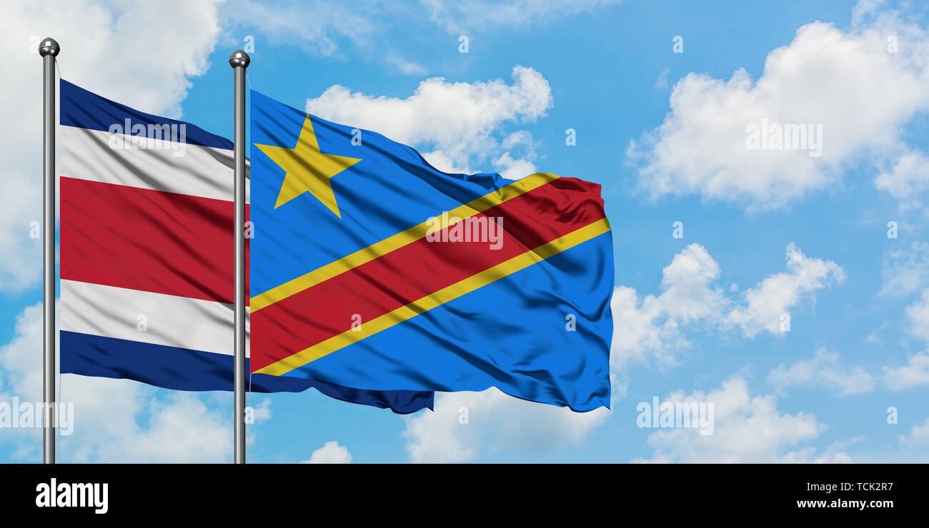 Costa Rica and Congo flag waving in the wind against white cloudy blue ...