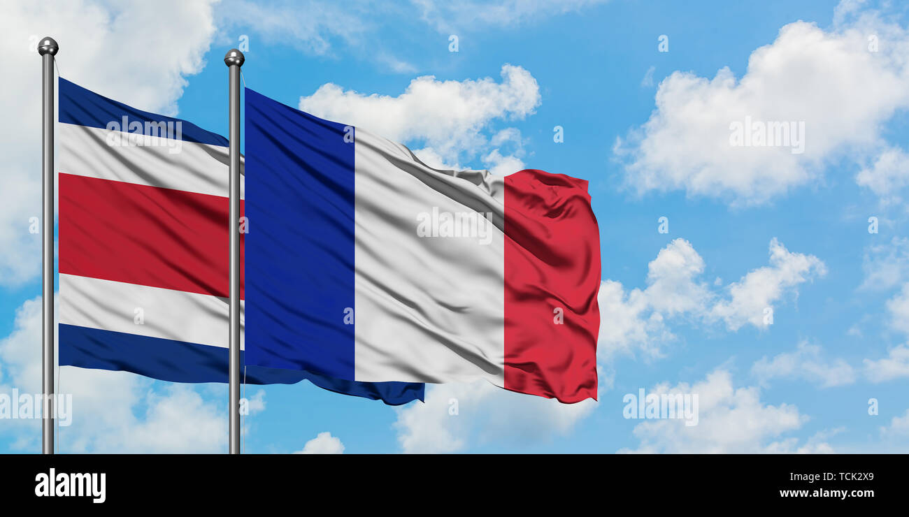 Costa Rica and France flag waving in the wind against white cloudy blue ...