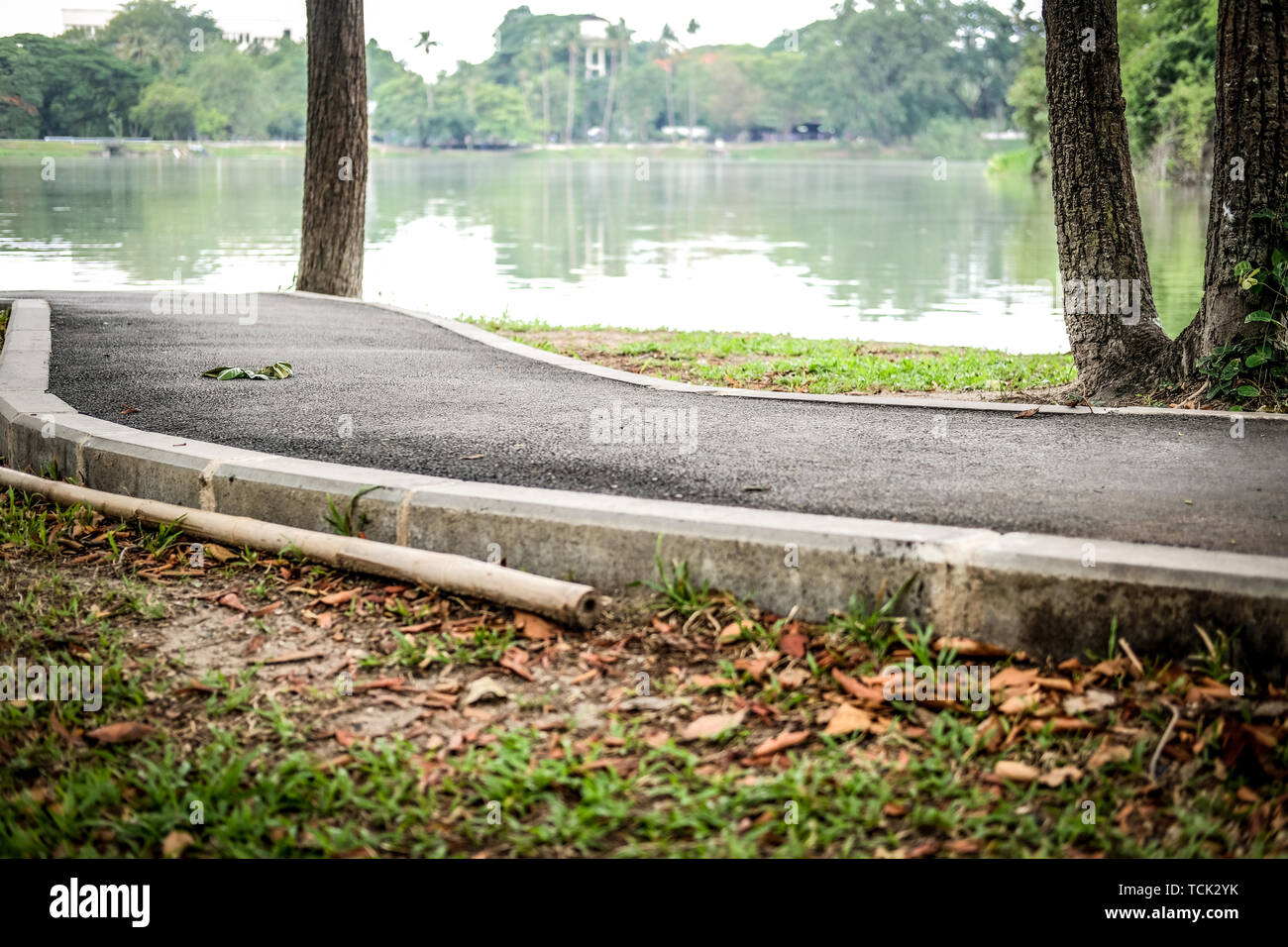 pathway walkway path near pond in outdoor garden park Stock Photo - Alamy