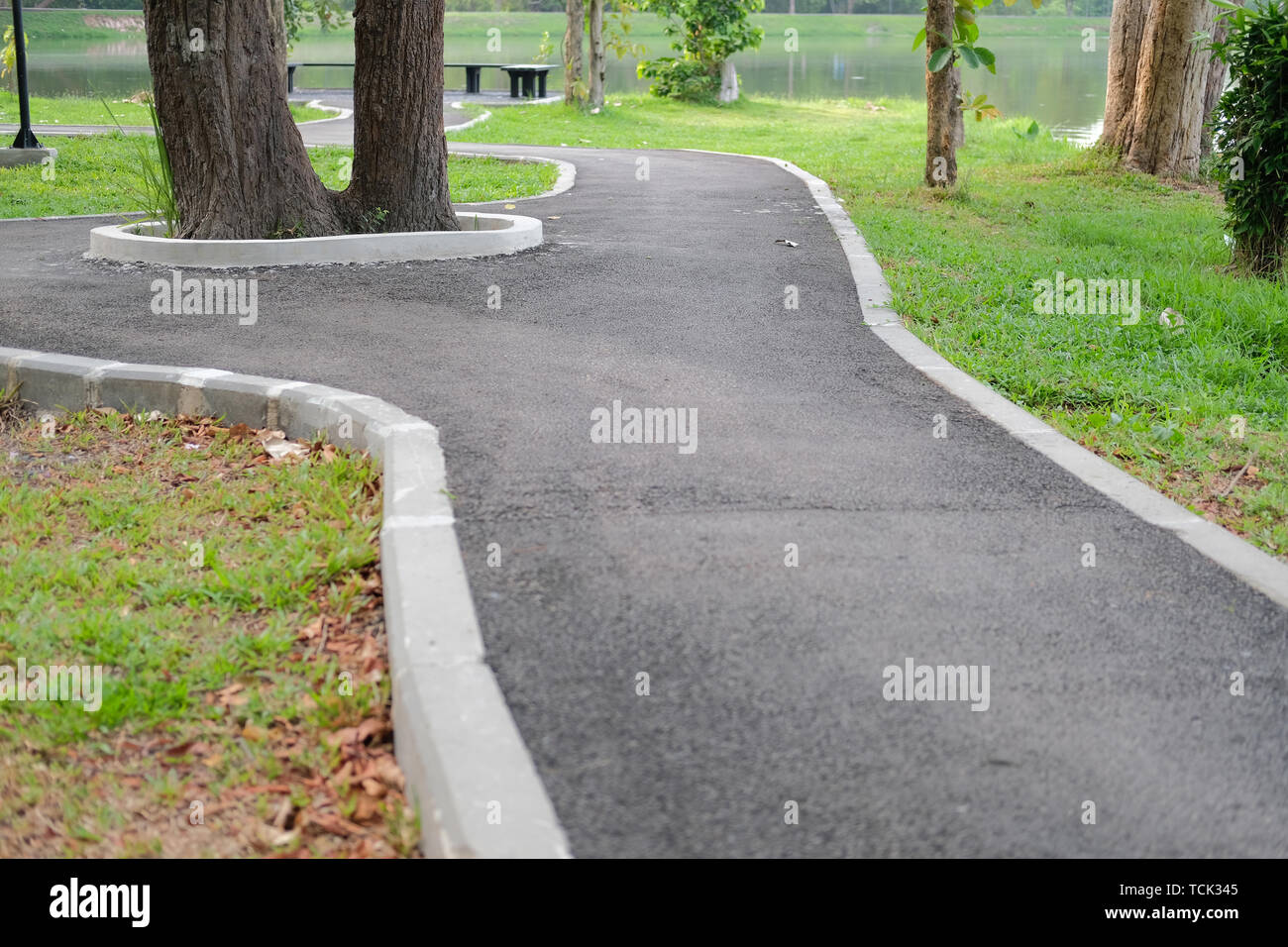 pathway walkway path near pond in outdoor garden park Stock Photo - Alamy