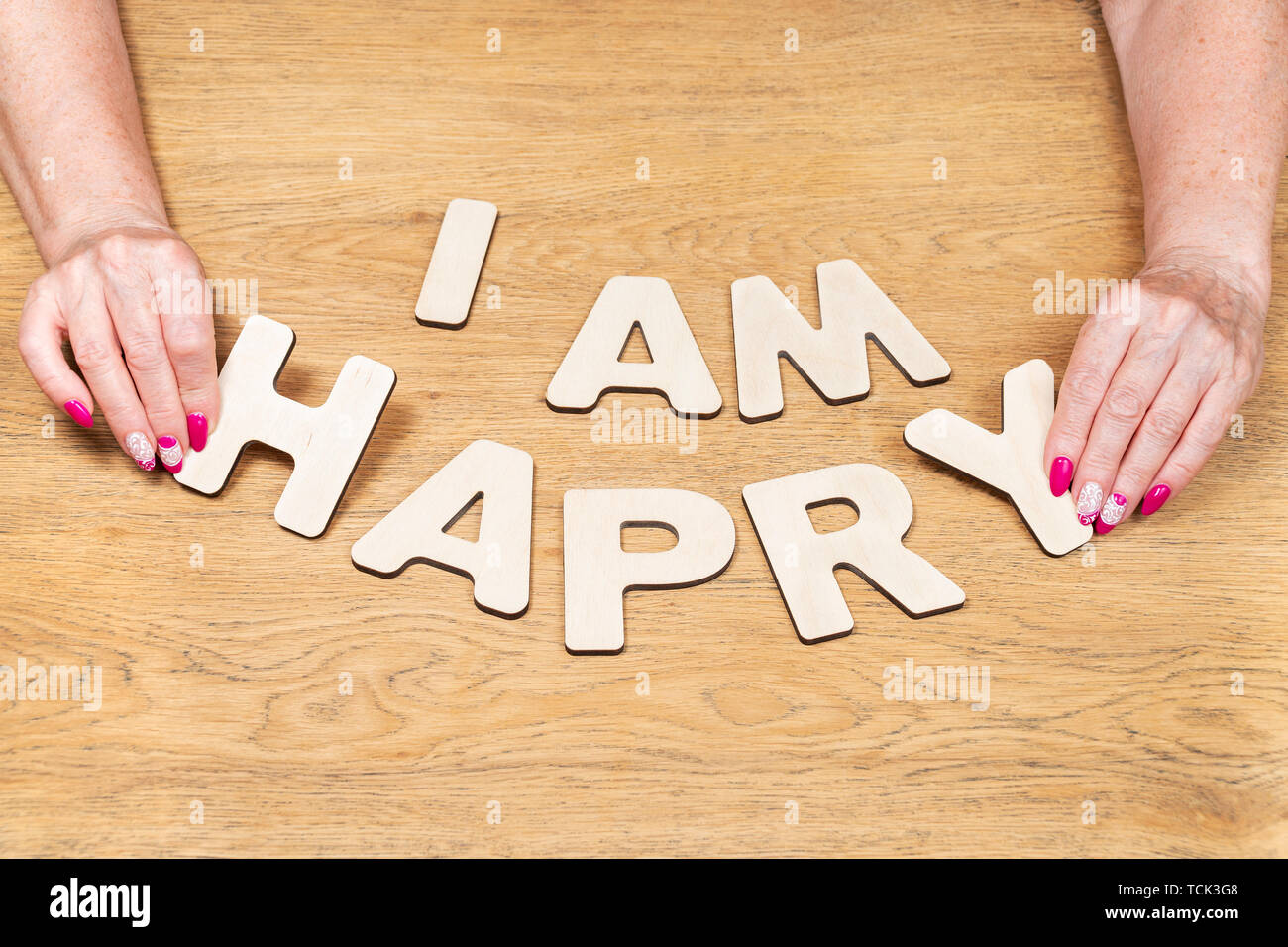 old female hands laid out on the table of wooden letters the phrase - I ...