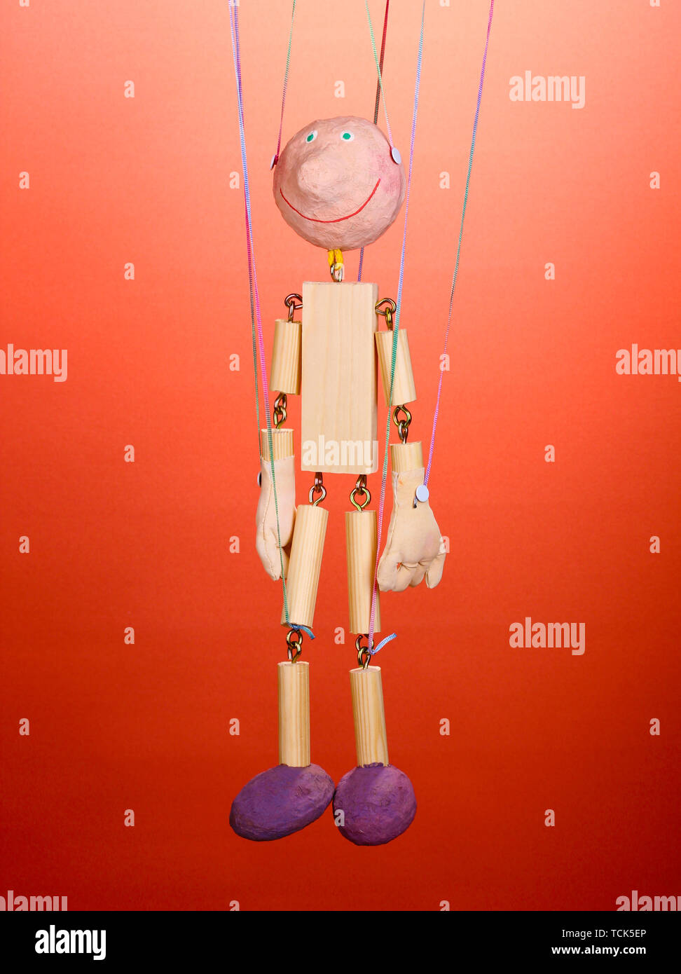 Wooden puppet on red background Stock Photo - Alamy
