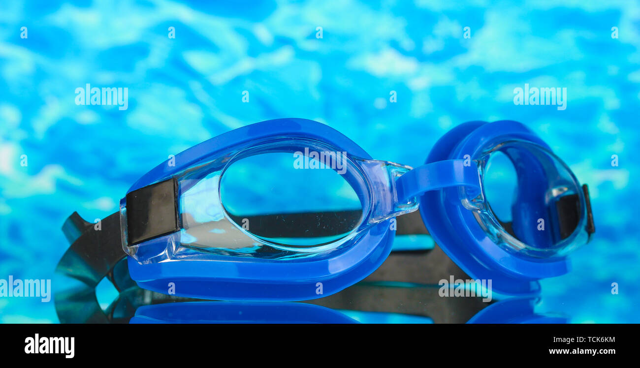 blue swim goggles with drops on blue sea background Stock Photo - Alamy
