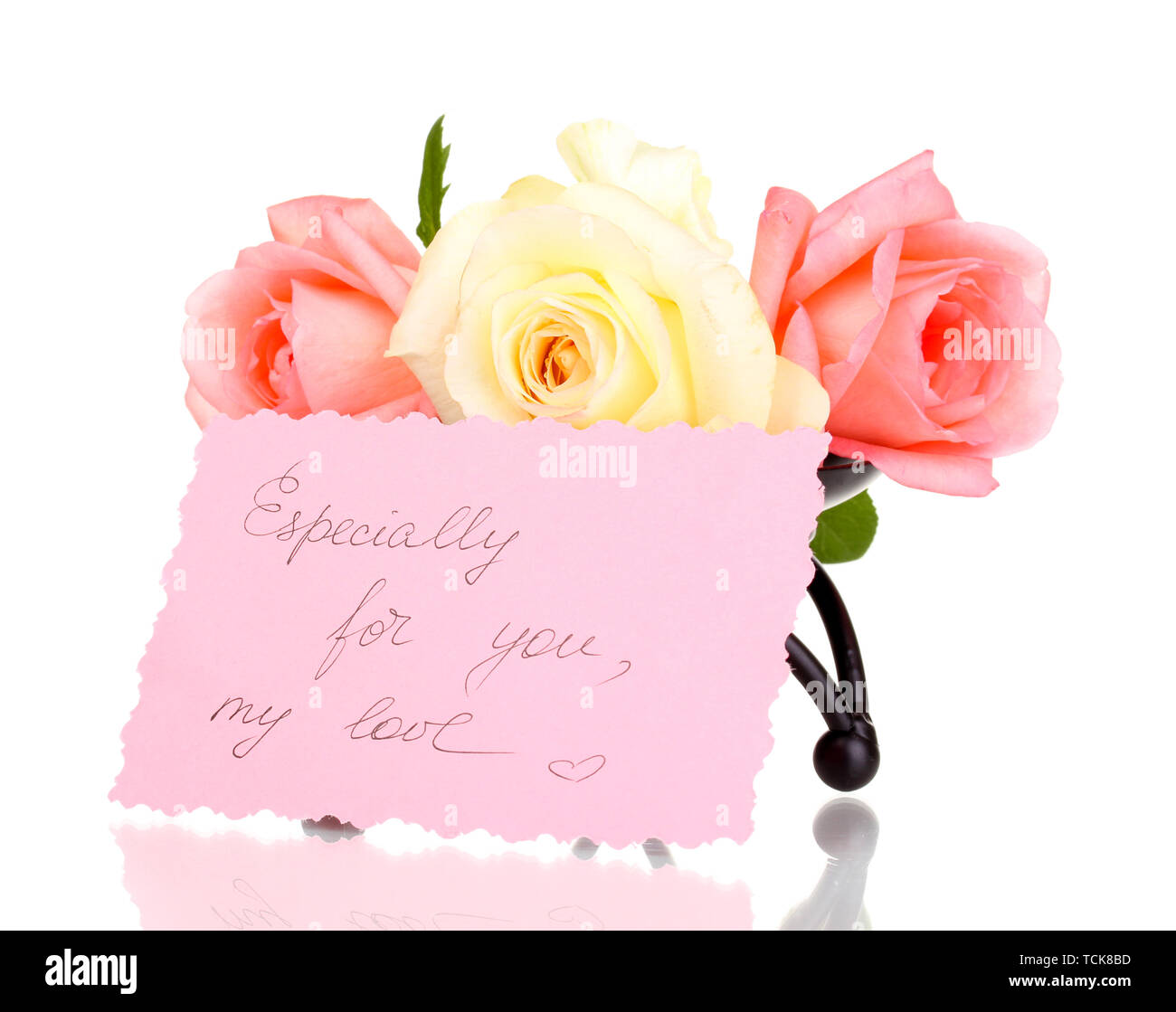 Three roses on metal stand with card isolated on white Stock Photo - Alamy