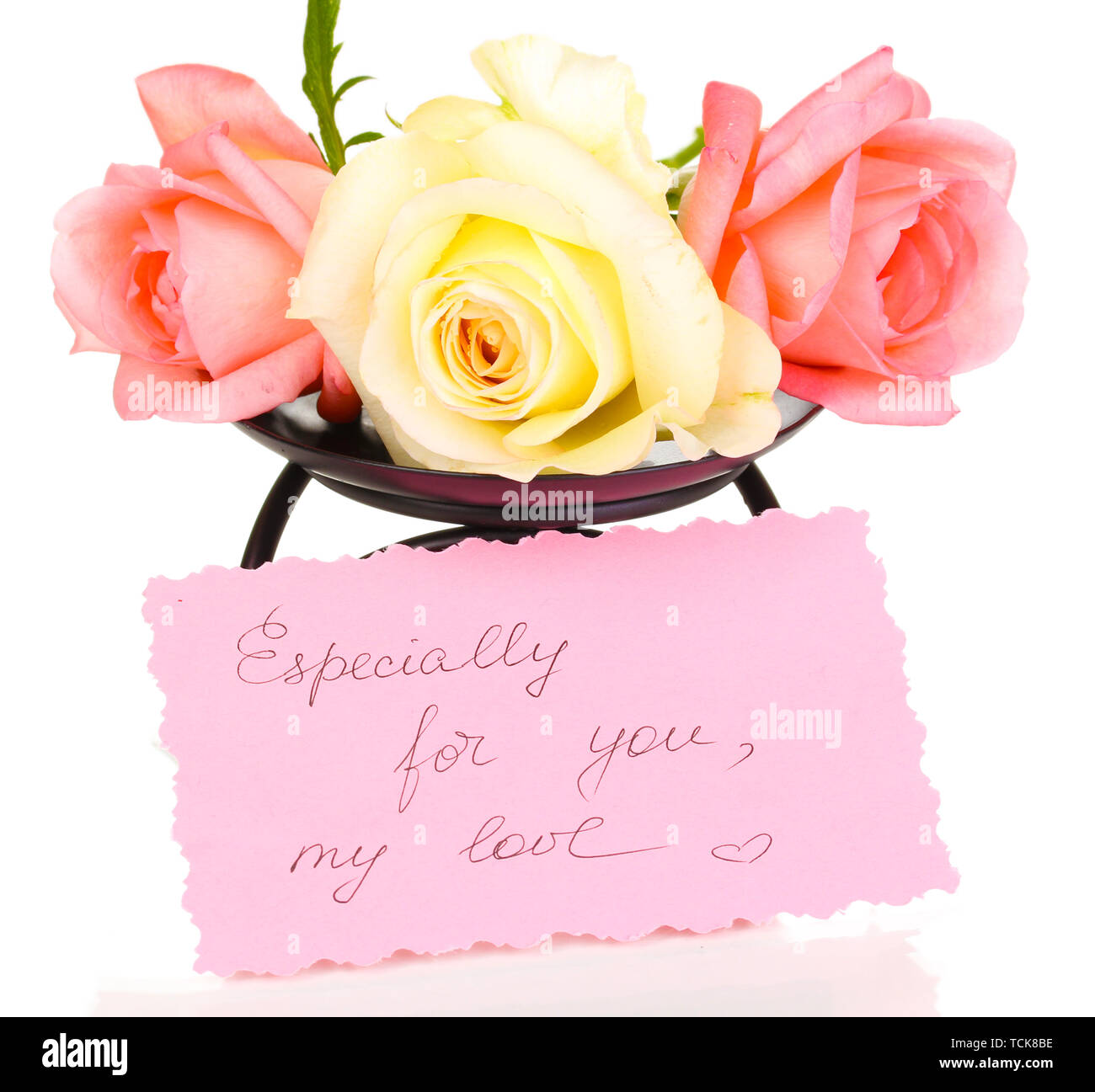 Three roses on metal stand with card isolated on white Stock Photo - Alamy