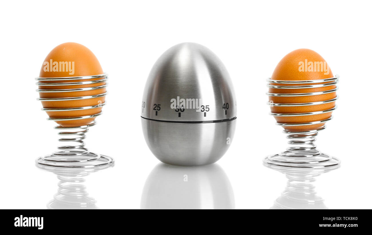 egg timer and egg in metal stand isolated on white Stock Photo - Alamy