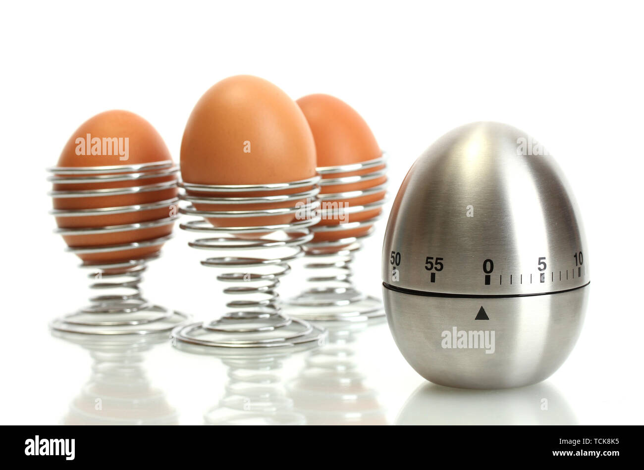 egg timer and egg in metal stand isolated on white Stock Photo - Alamy