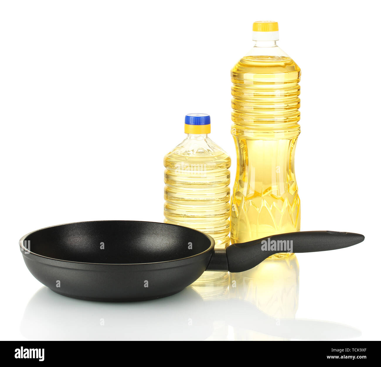 Pan with bottle of oil isolated on white Stock Photo - Alamy