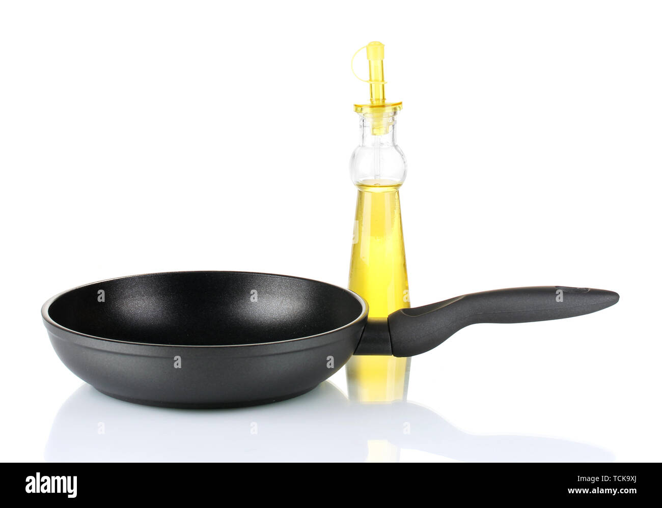 Pan with bottle of oil isolated on white Stock Photo - Alamy