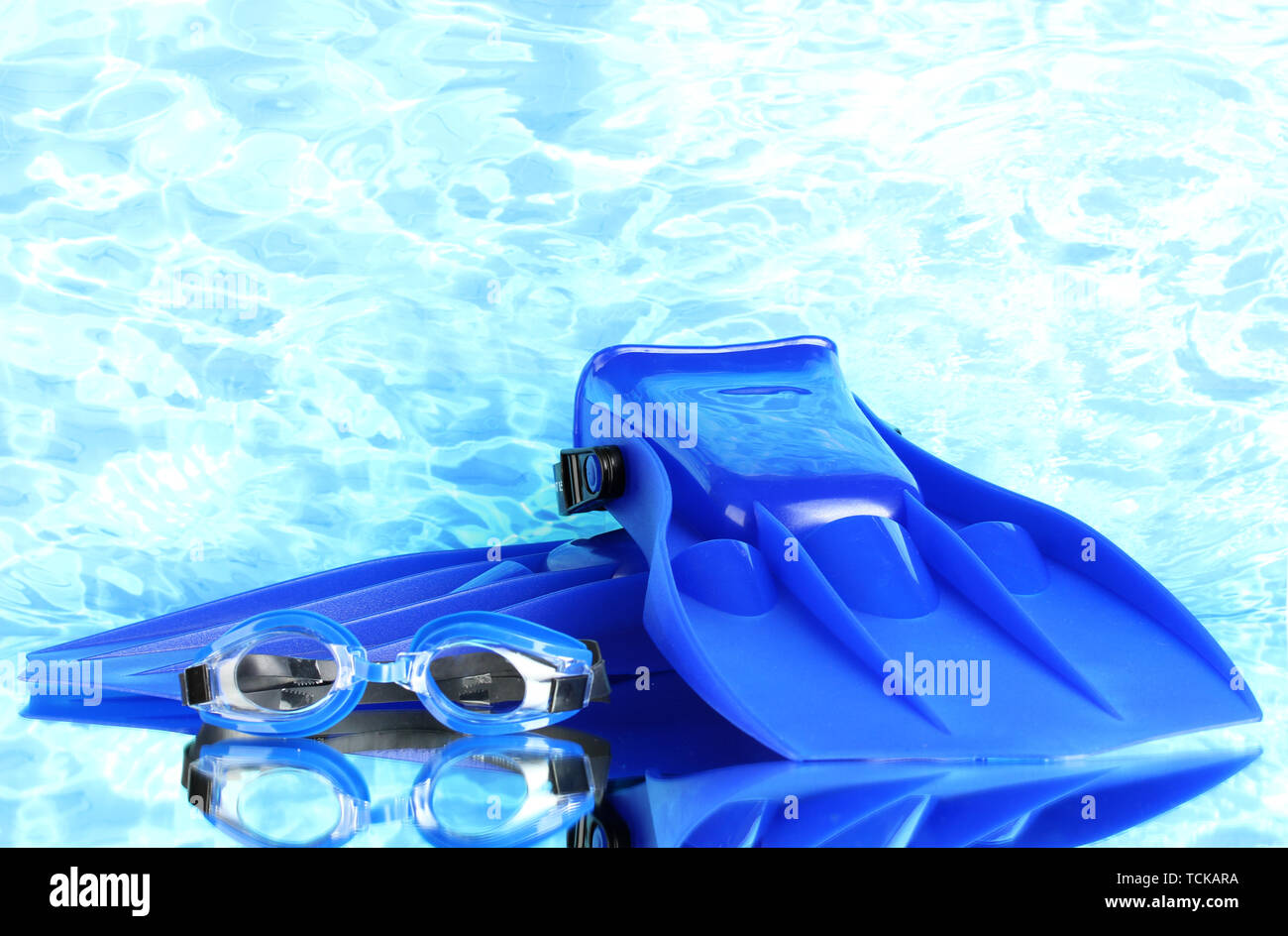 blue flippers and goggles on blue sea background Stock Photo - Alamy