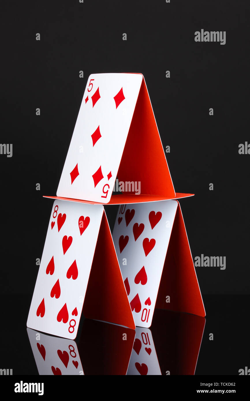 Card house isolated on black Stock Photo - Alamy