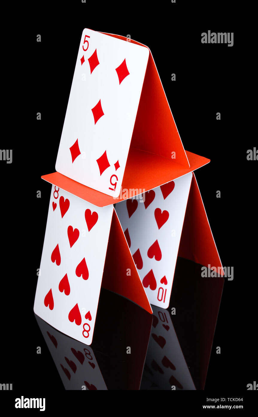 Card house isolated on black Stock Photo - Alamy