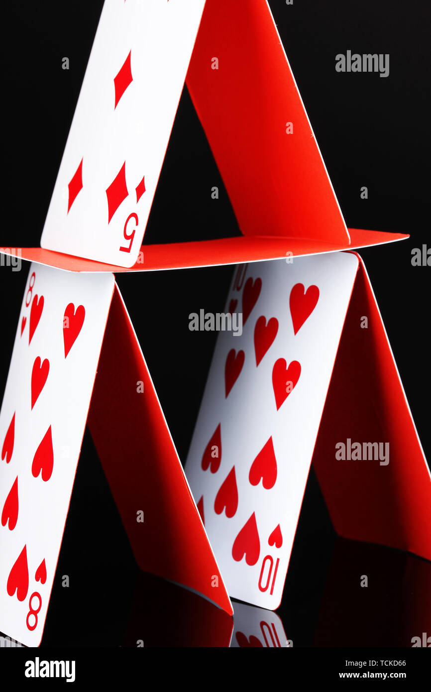 Card house isolated on black Stock Photo - Alamy