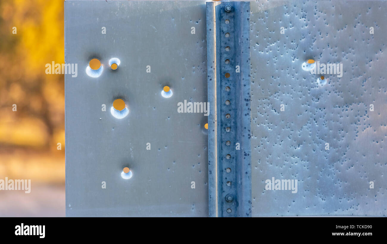 Panorama Back view of shiny metal sign board against blurry background ...