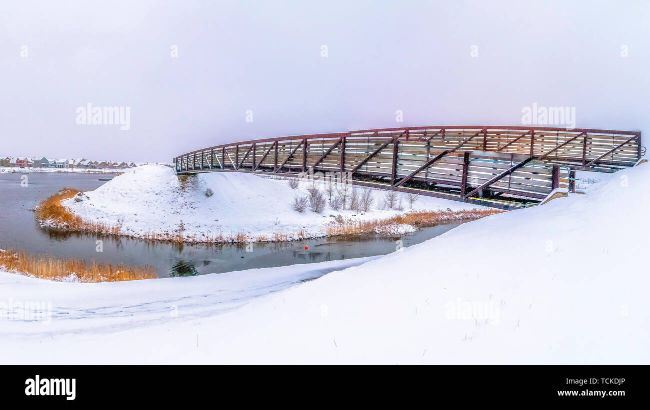 Panorama Panorama of a silvery lake with snow covered shore and metal ...