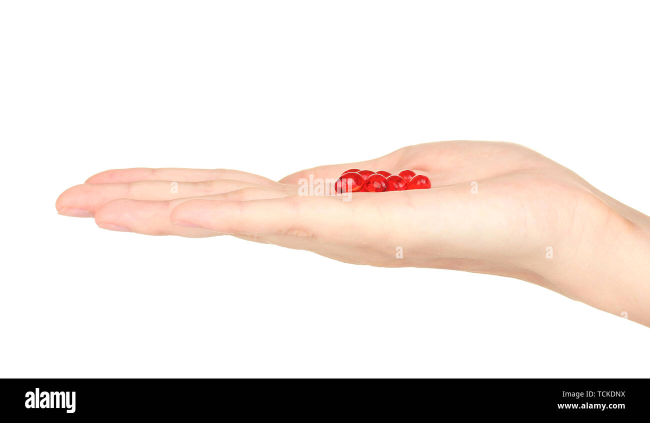 Woman's hand holding a red pill on white background close-up Stock ...