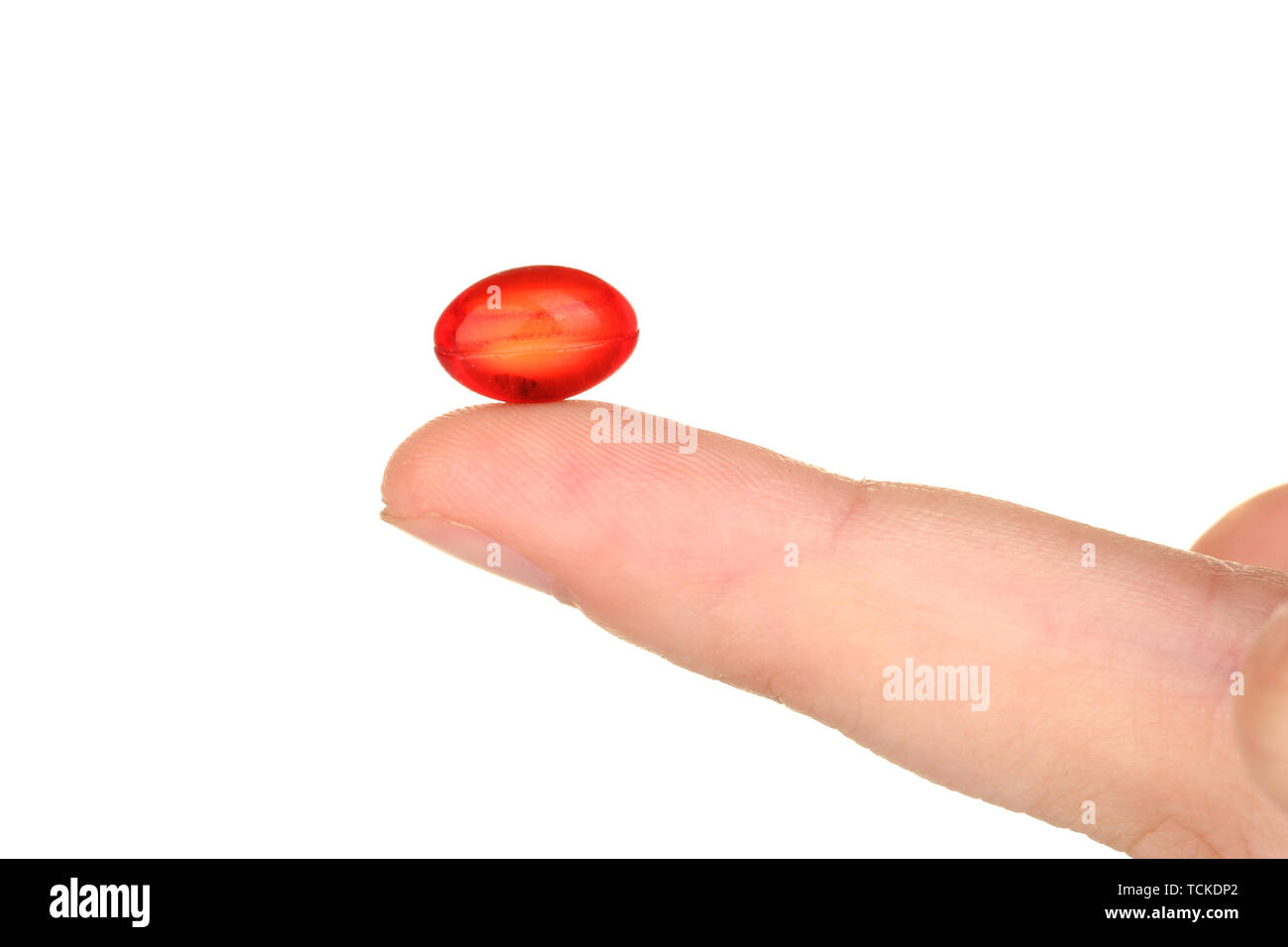 Woman's hand holding a red pill on white background close-up Stock ...