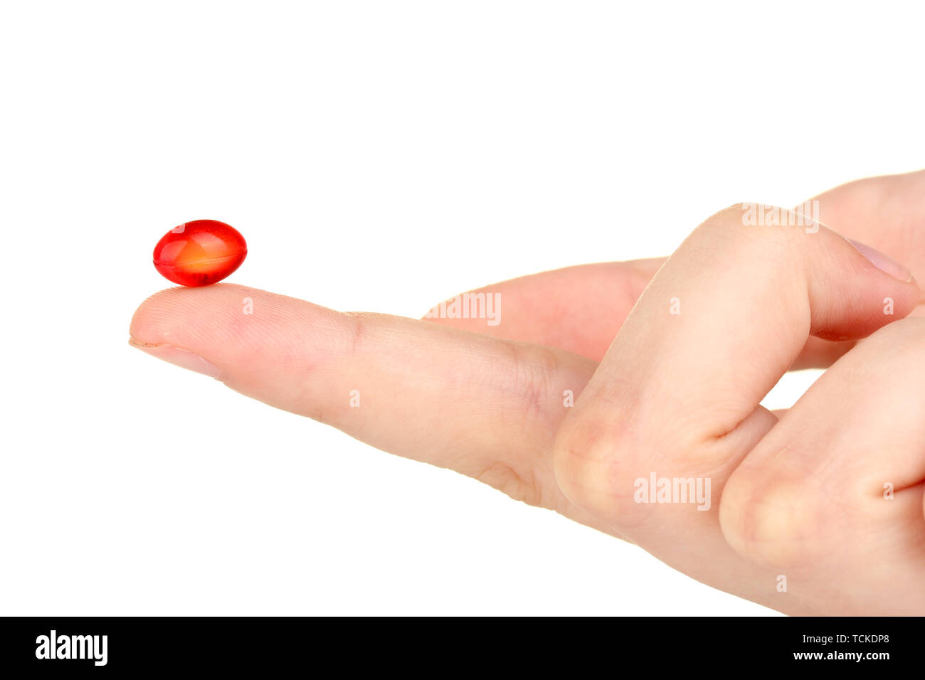 Woman's hand holding a red pill on white background close-up Stock ...