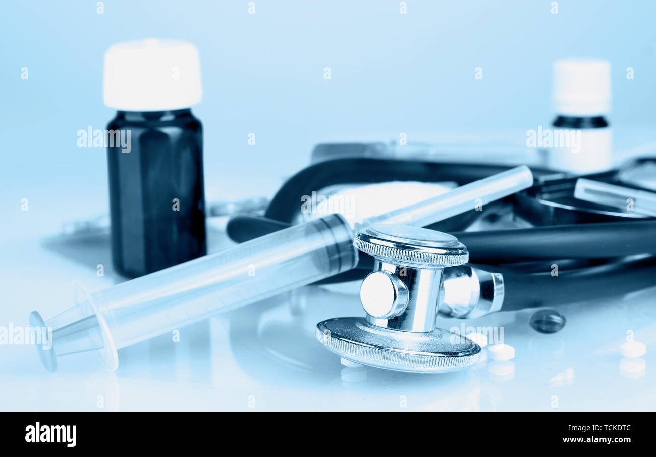 Medicines and stethoscope in blue light Stock Photo - Alamy