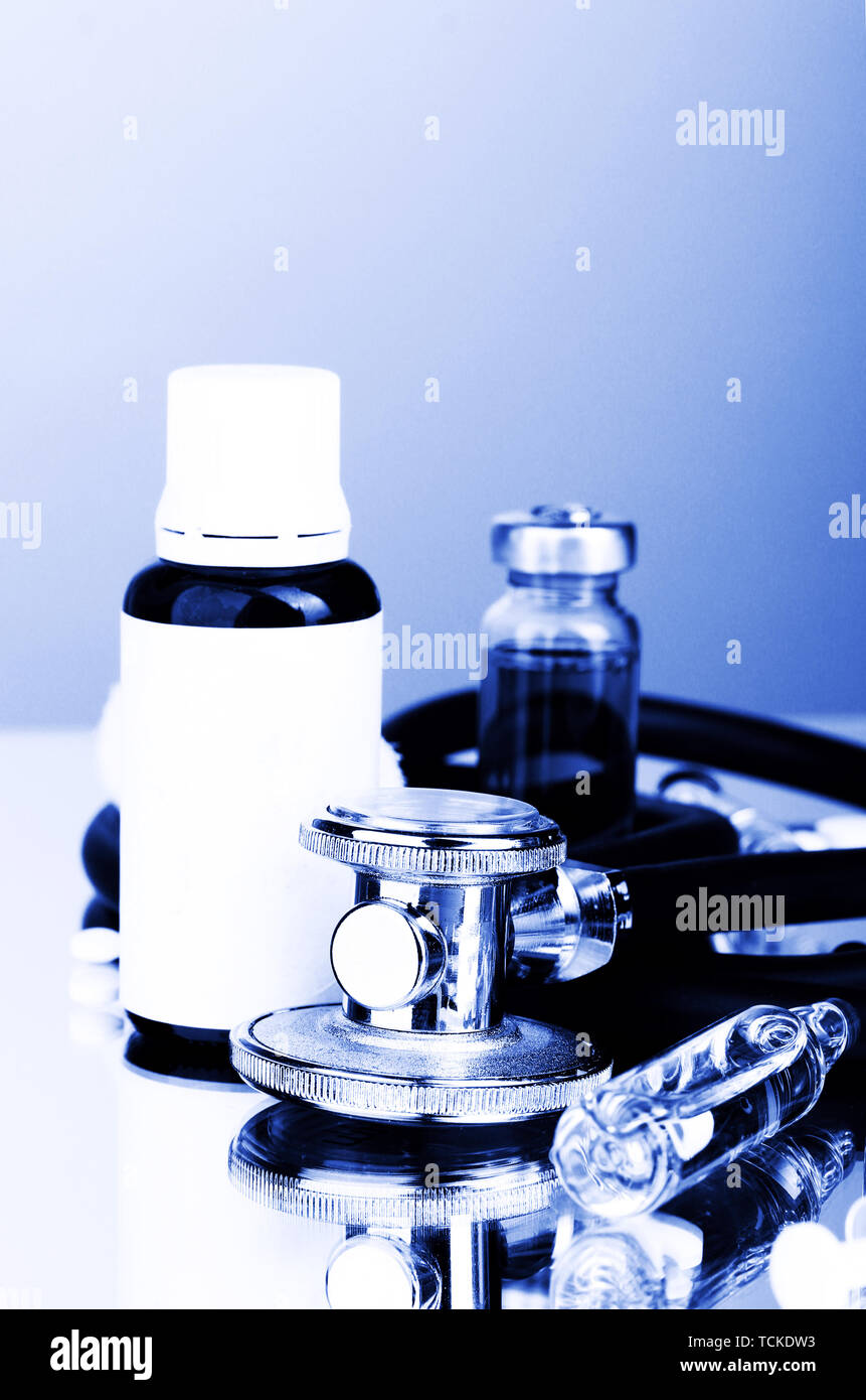 Medicines and stethoscope in blue light Stock Photo - Alamy