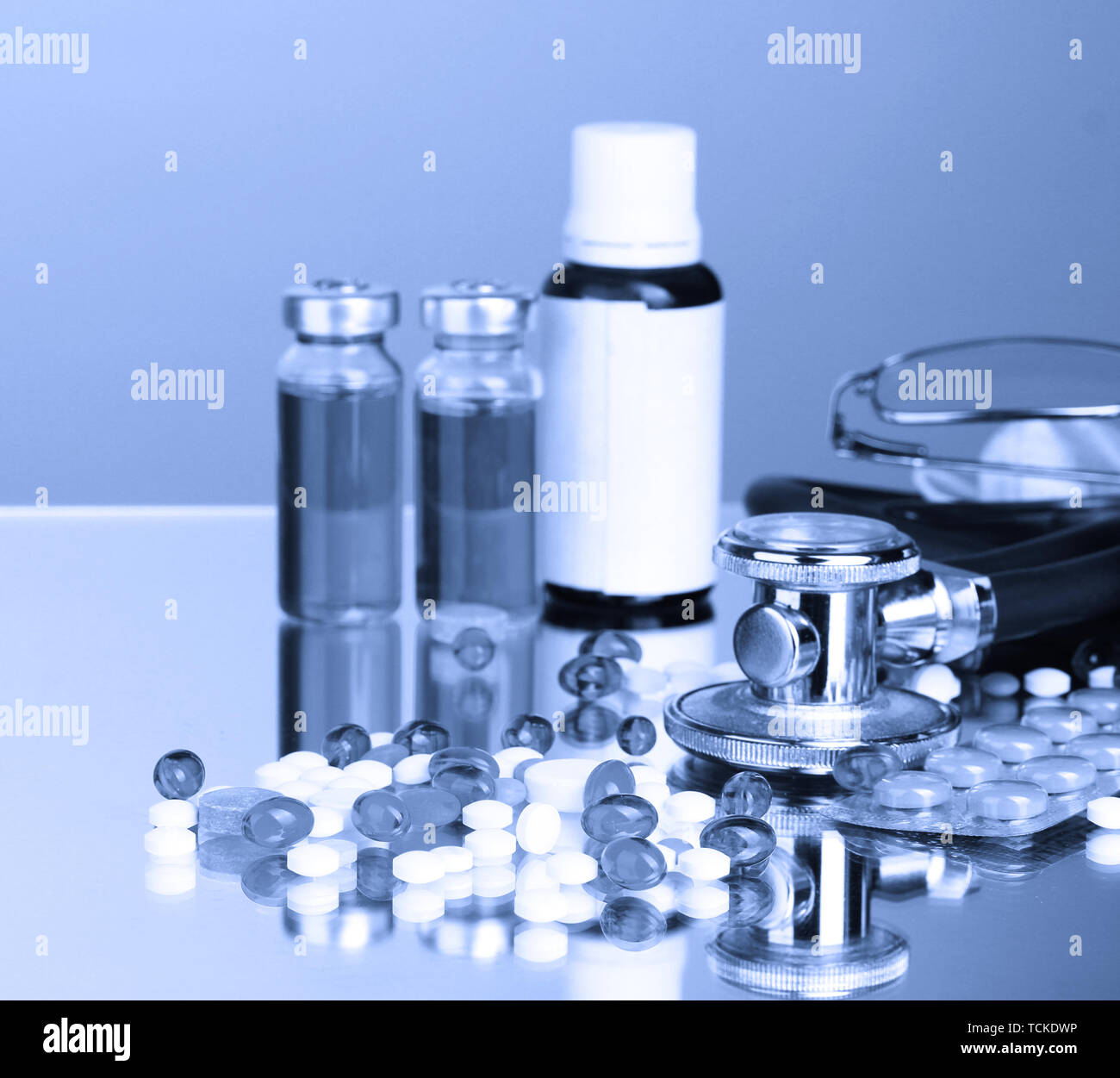 Medicines and stethoscope in blue light Stock Photo - Alamy