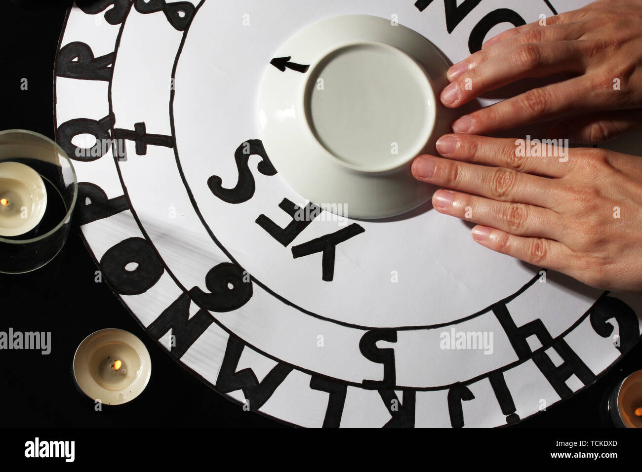 spiritualistic seance by candlelight close-up Stock Photo - Alamy