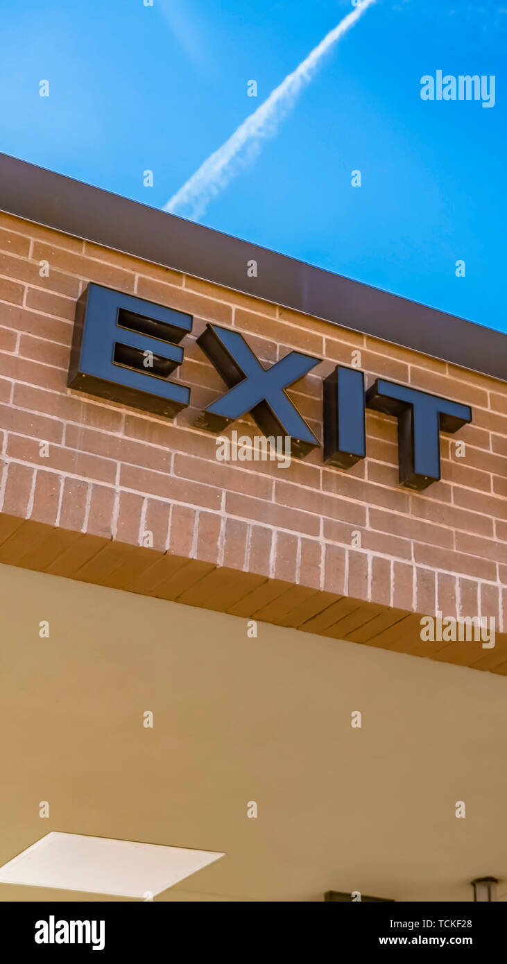 Panorama Exit only sign on the exterior brick wall of a building with ...