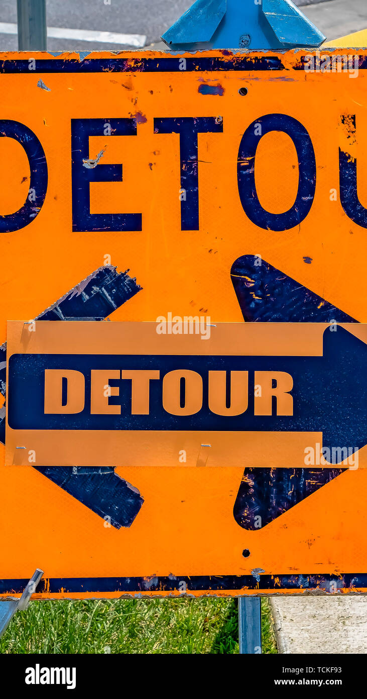 Panorama Close up of a weathered orange and blue Detour sign with arrow ...