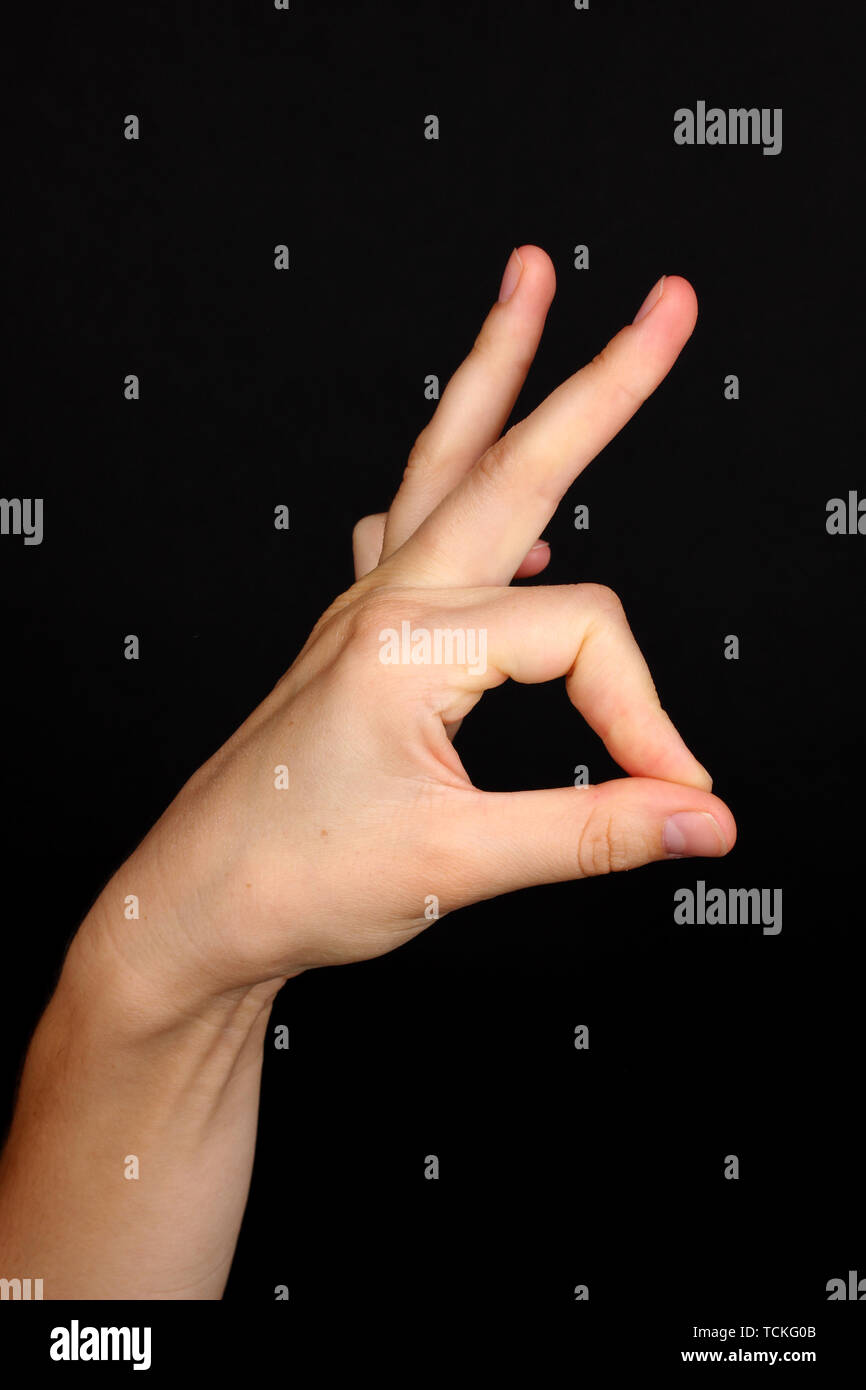 Hand making sign isolated on black Stock Photo - Alamy