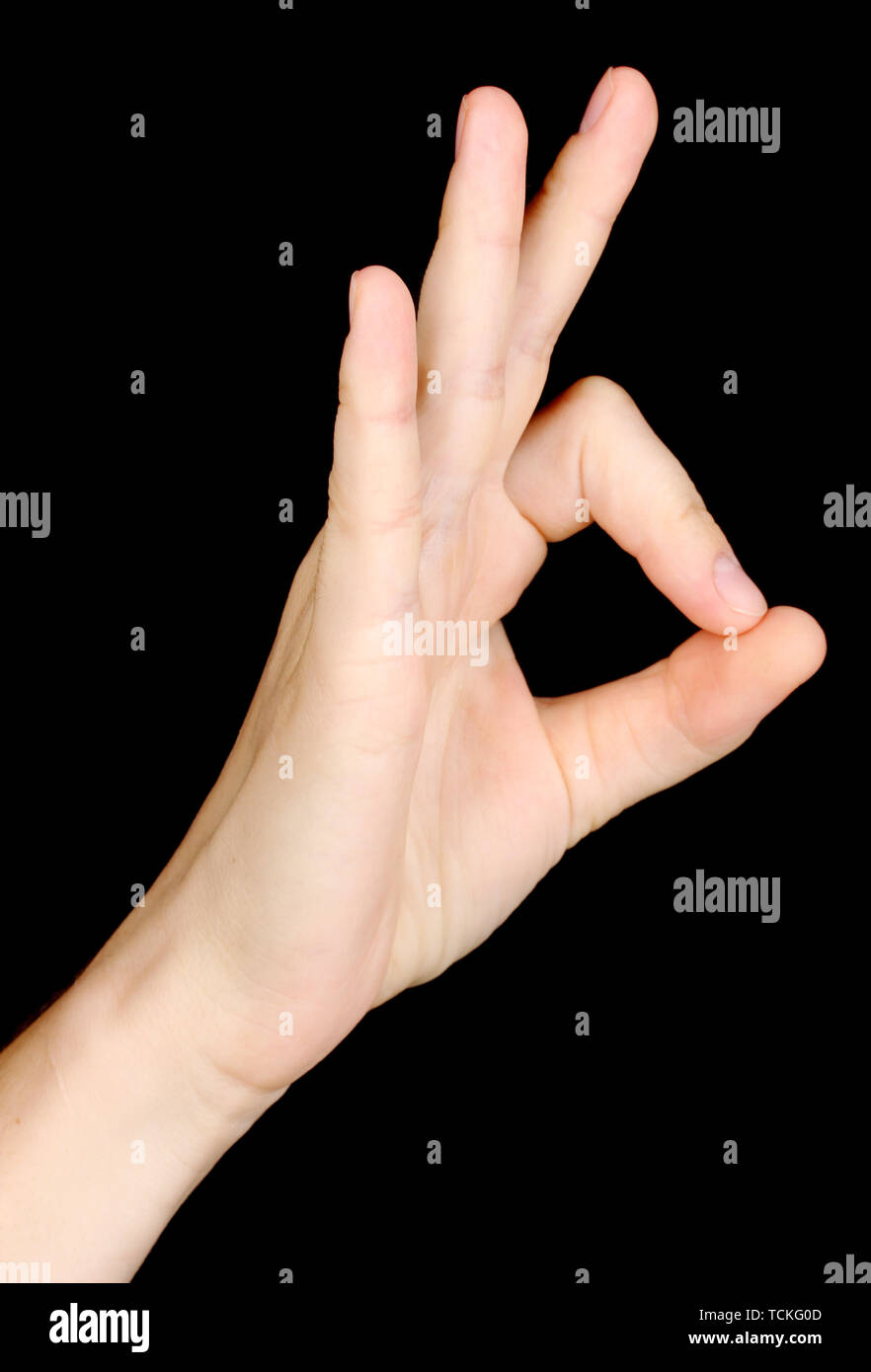Hand making sign isolated on black Stock Photo - Alamy