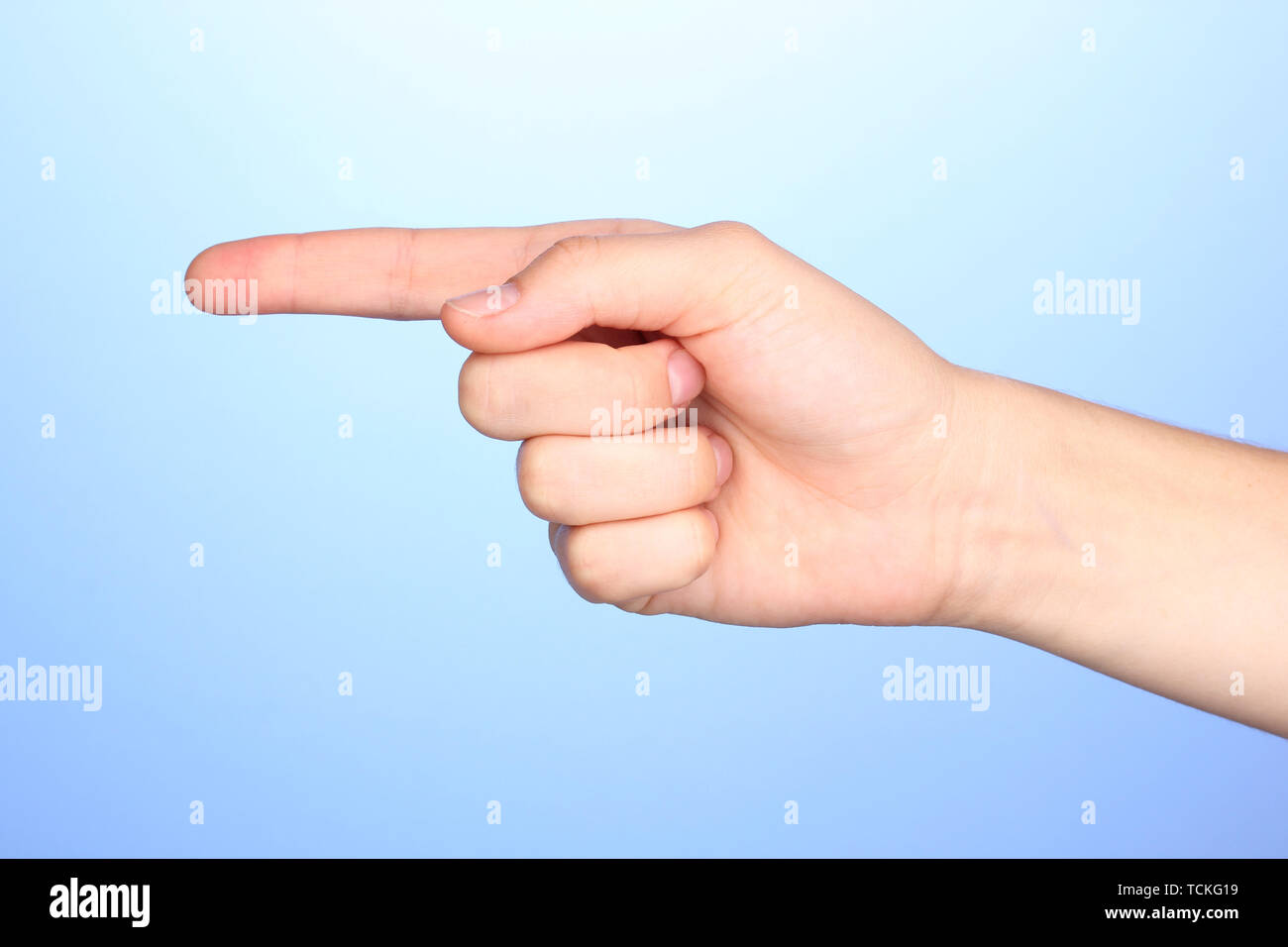 Hand making sign on blue background Stock Photo - Alamy