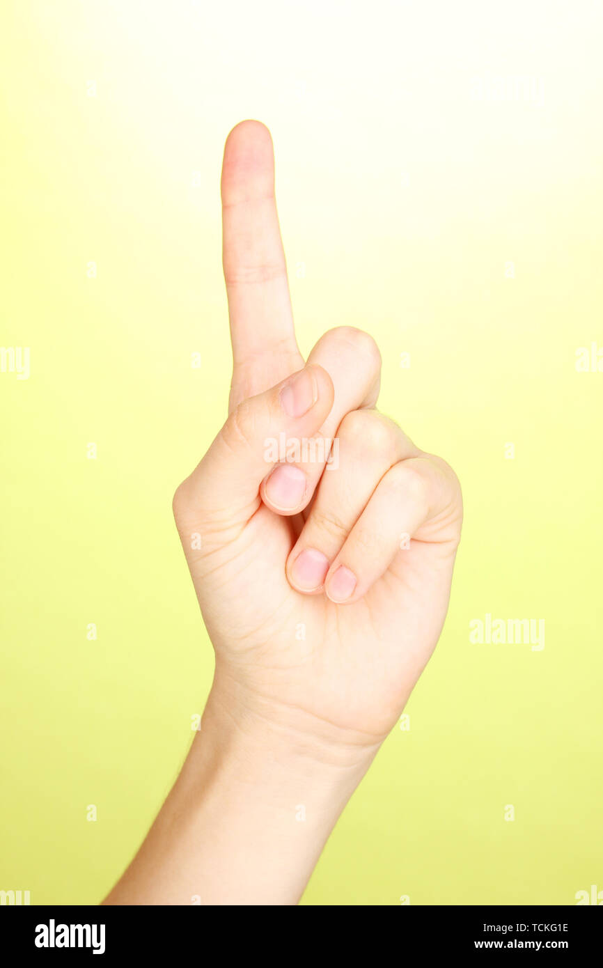 Hand making sign on green background Stock Photo - Alamy