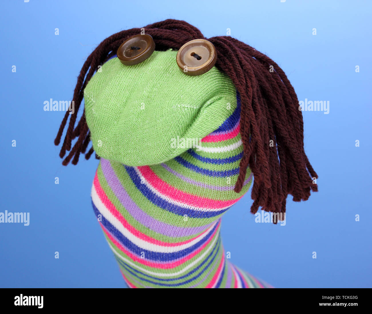 Cute sock puppet on blue background Stock Photo - Alamy