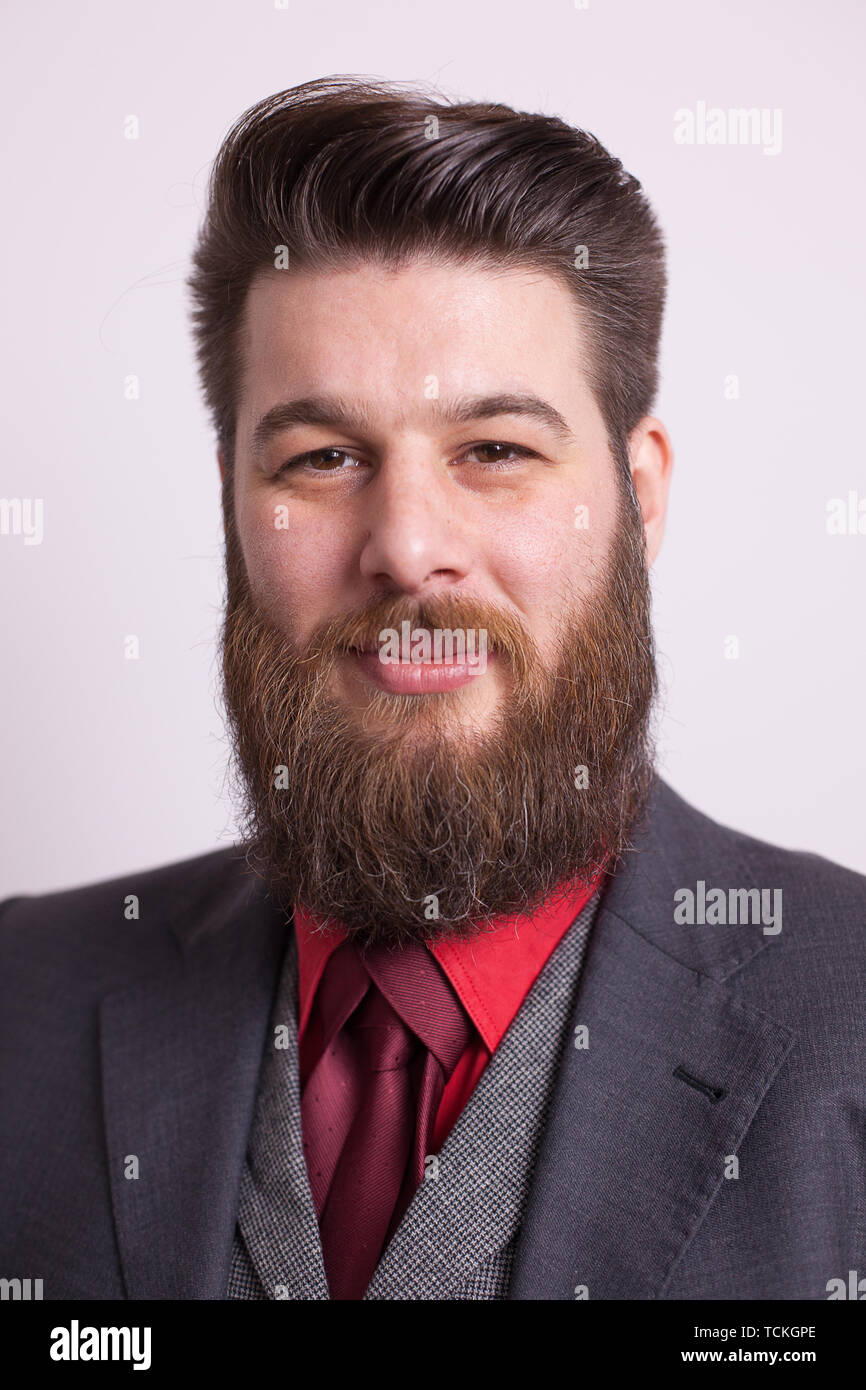 Studio portrait of handsome bearded man over white background. Stylish ...