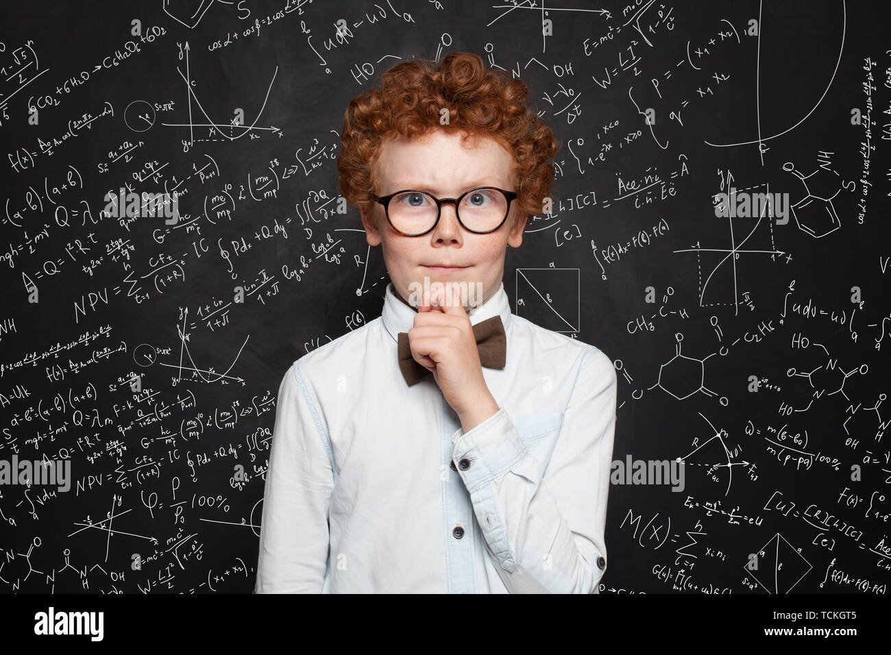 Thinking child boy student on blackboard background with science ...