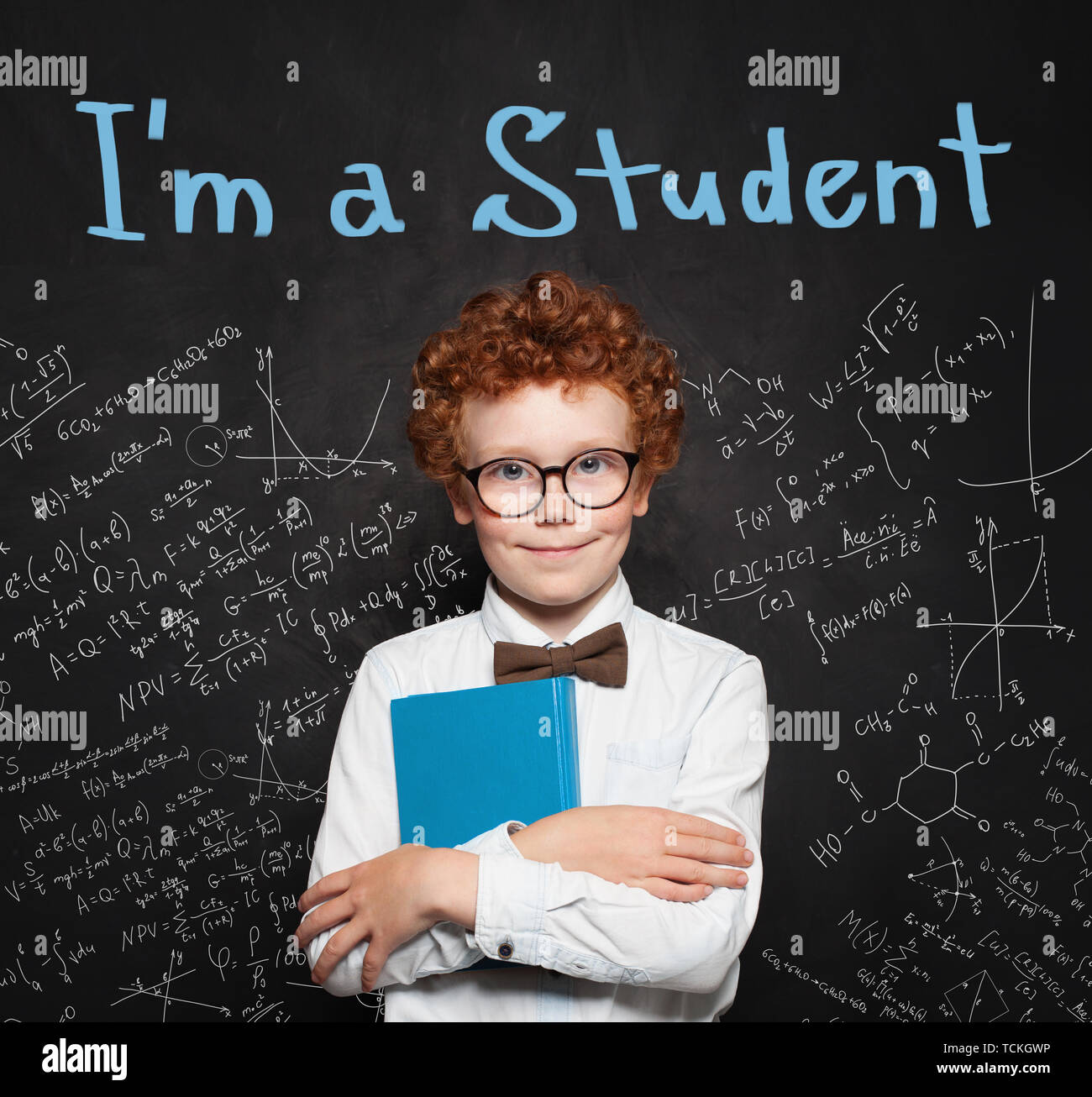 Smart child student on blackboard background with science formulas ...