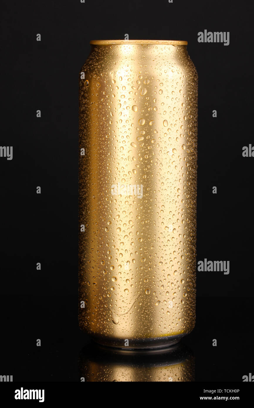 golden can with water drops isolated on black Stock Photo - Alamy