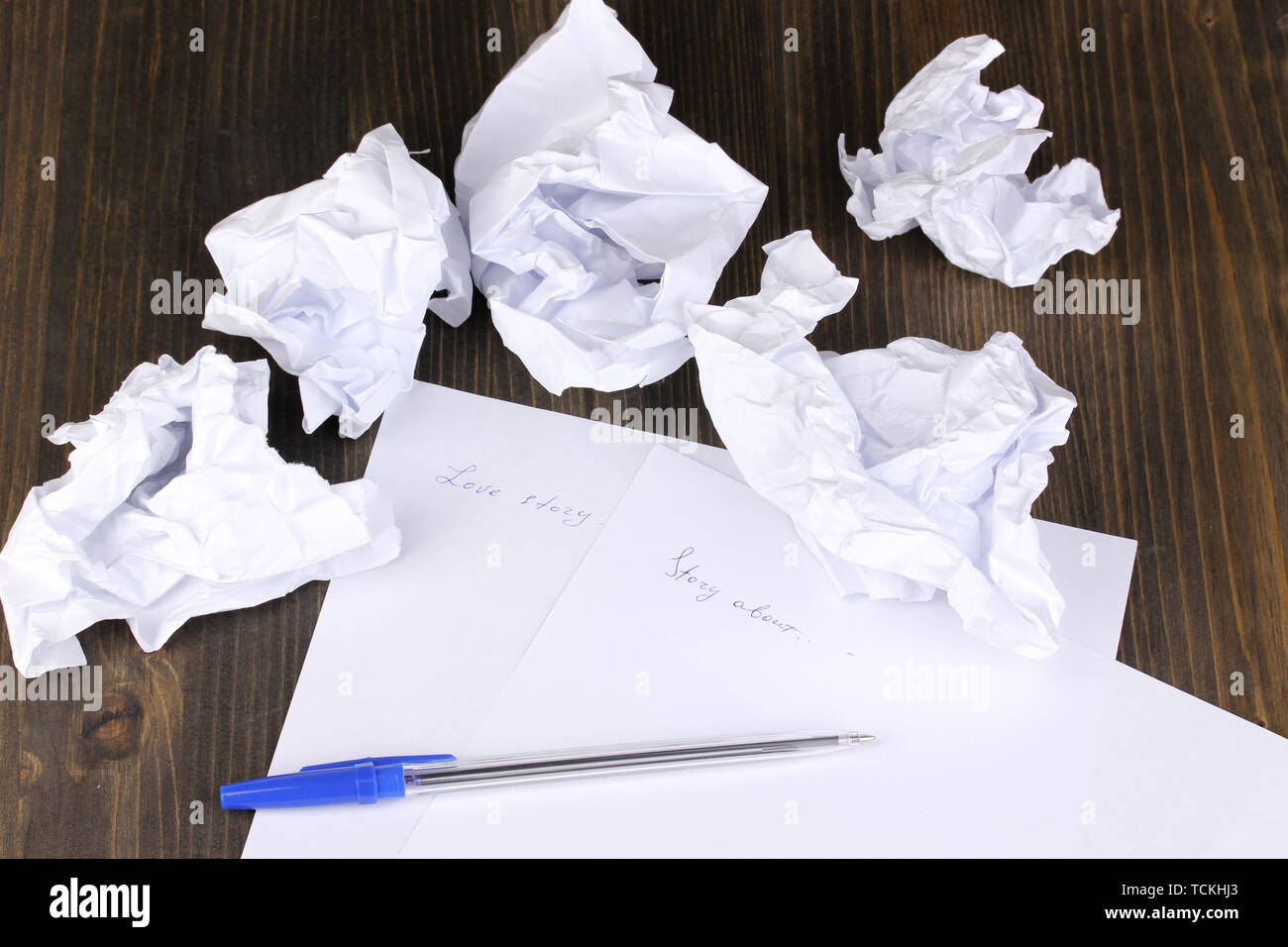 Creation of composition and crumpled sheets on wooden table Stock Photo ...