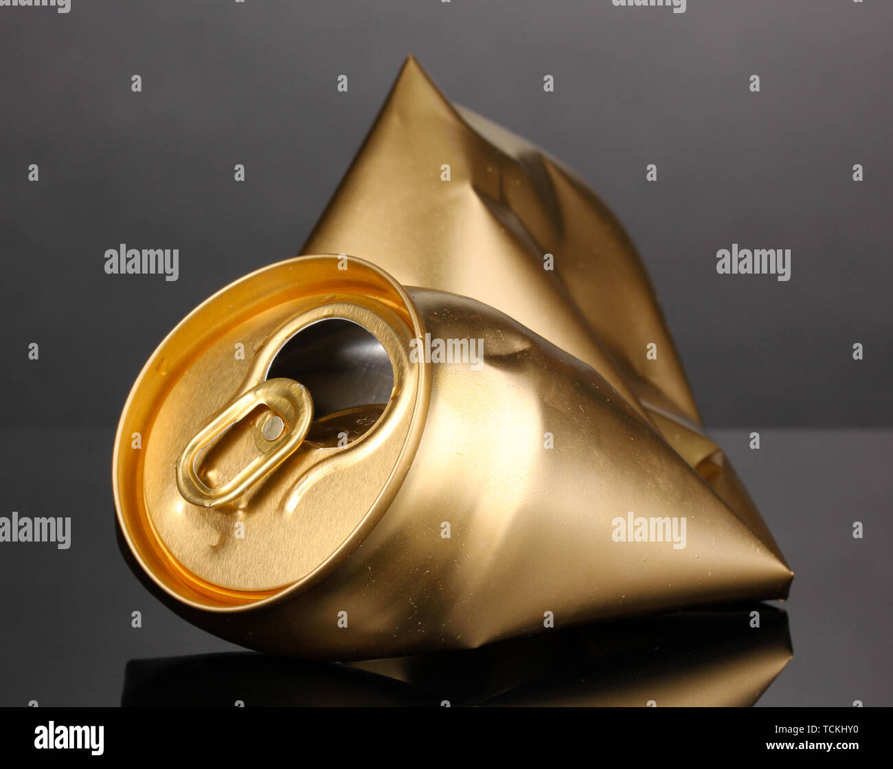 crumpled empty can on grey background Stock Photo - Alamy